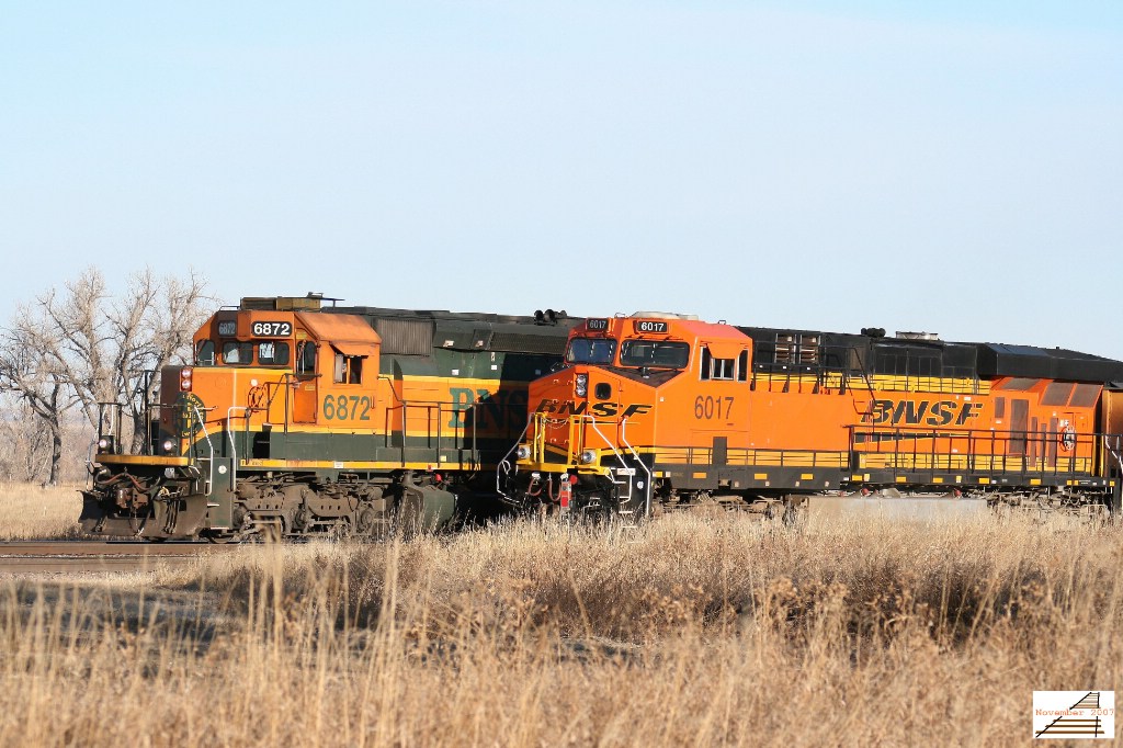 BNSF 6872 leading the H-NTWLAU passes BNSF 6017 (DP)
